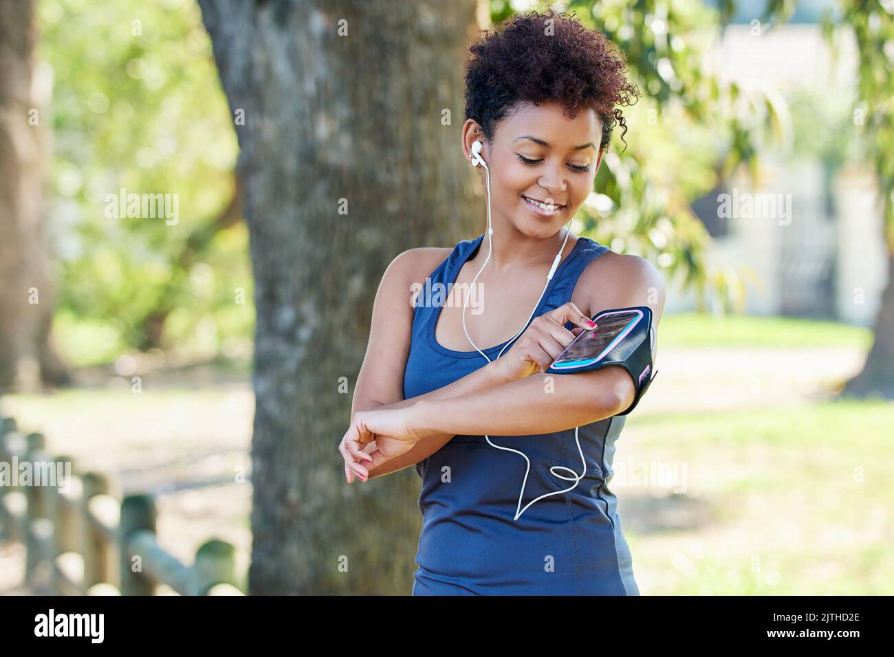 Getting fit and having fun along the way. a sporty young woman checking ...