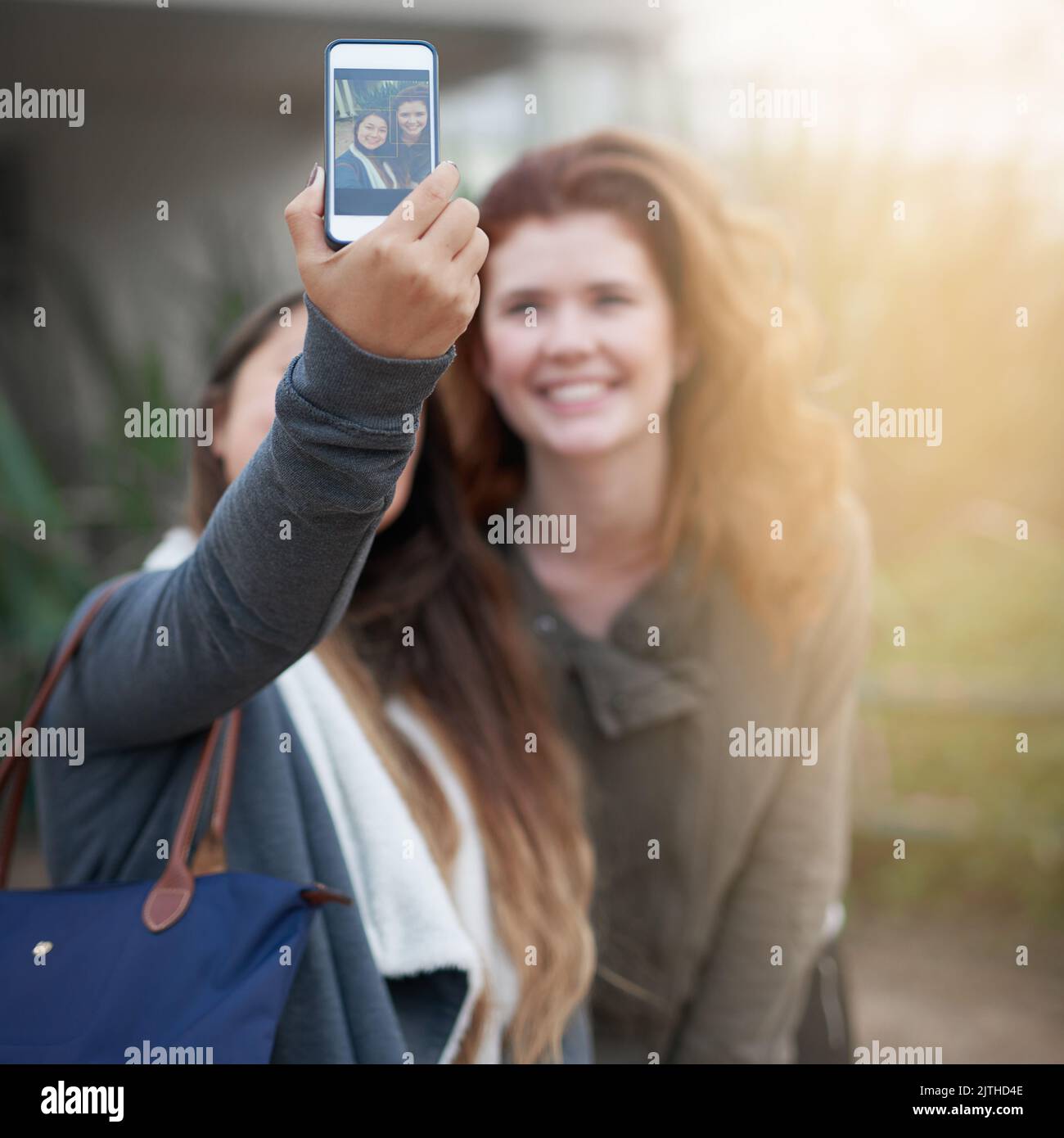 But first, let me take a selfie. two young women taking a selfie ...