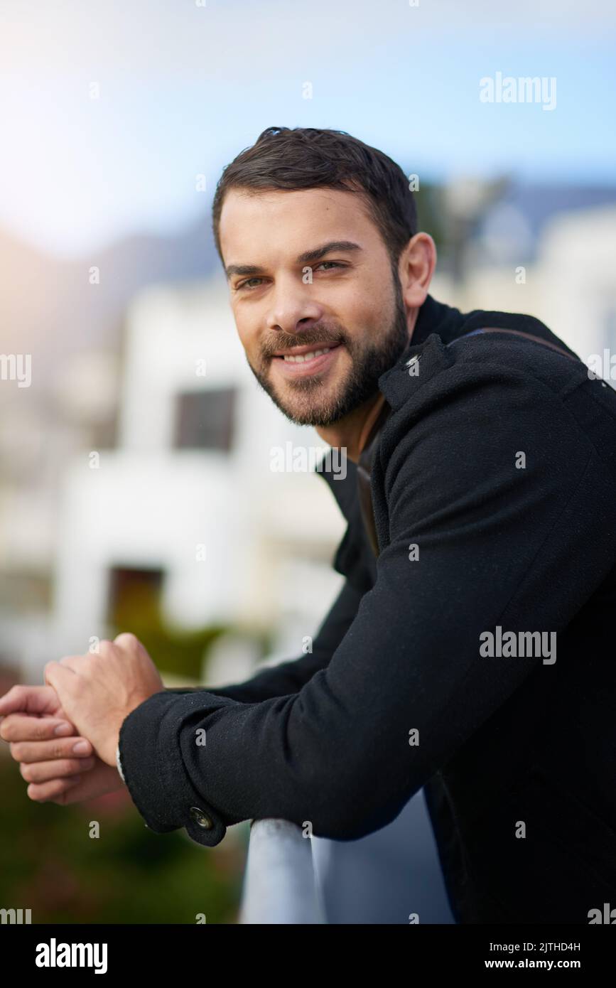 Feels good to get out. a handsome young man leaning against a railing ...