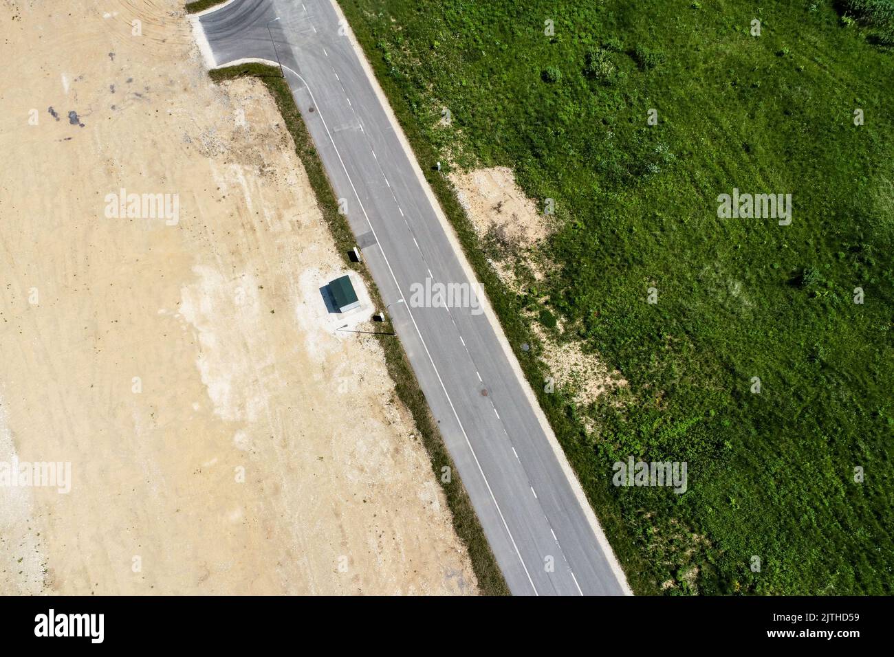 A highway that divides two deserted and vegetative parts of the field ...