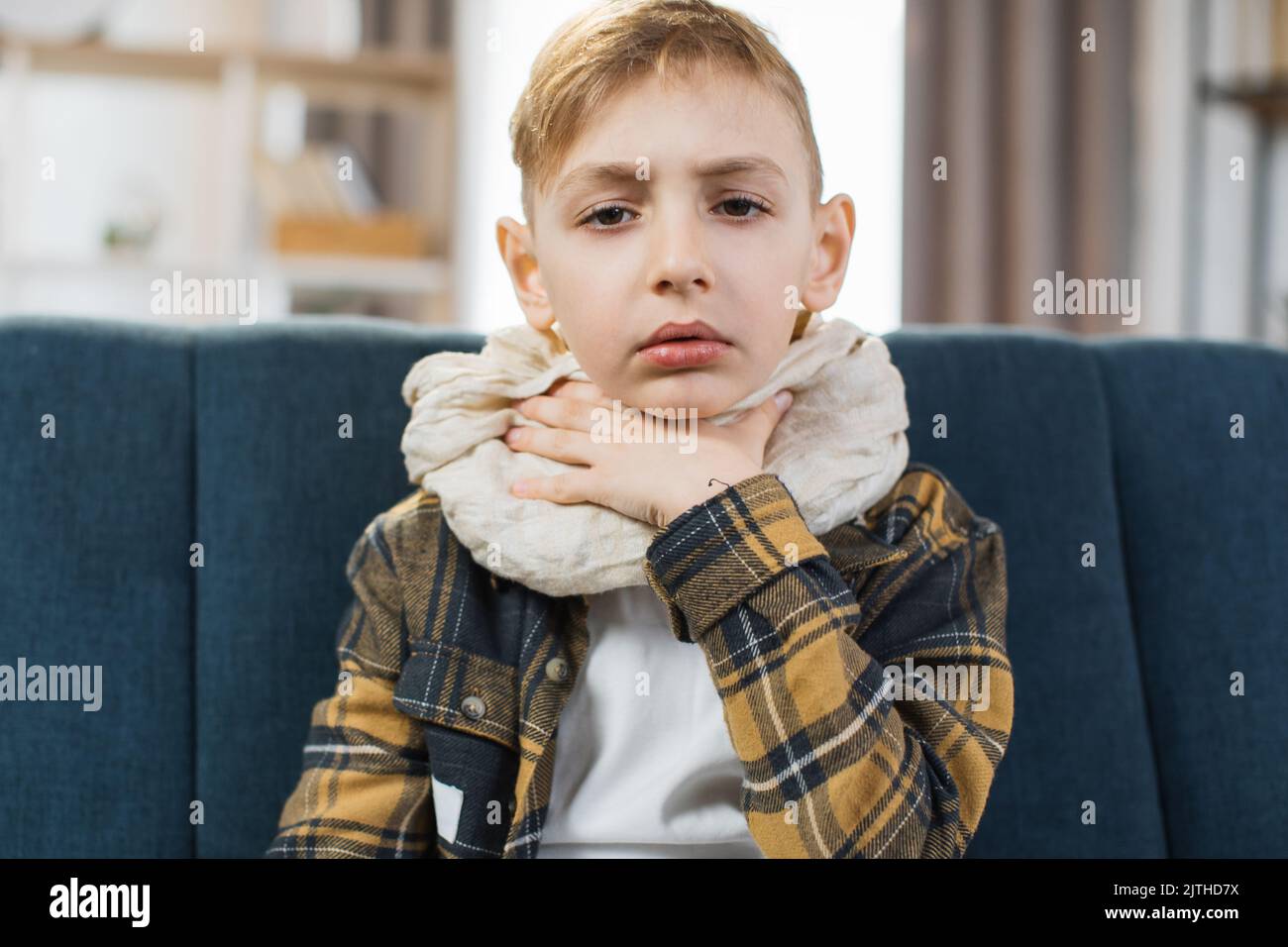 Cold and flu season. Sick teenage boy with high fever and sore throat ...