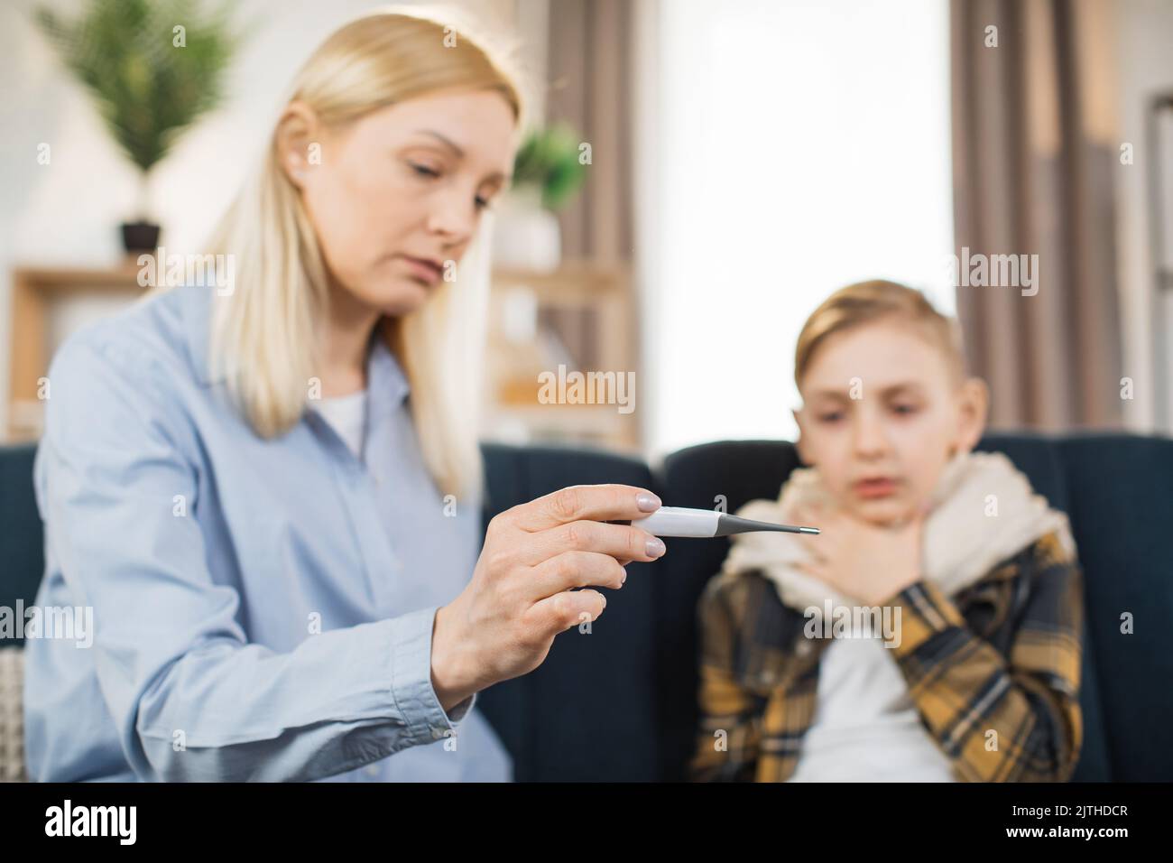 Close-up of mom's hand, holding thermometer. Excited pretty mother ...