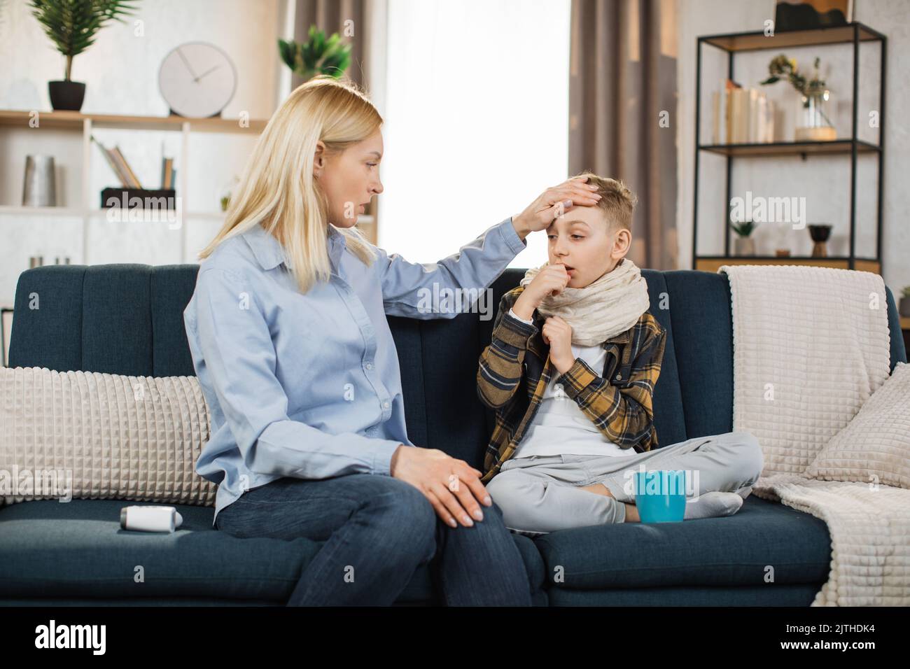 Stay at home. Mother taking care of her cute sick teen boy suffering ...