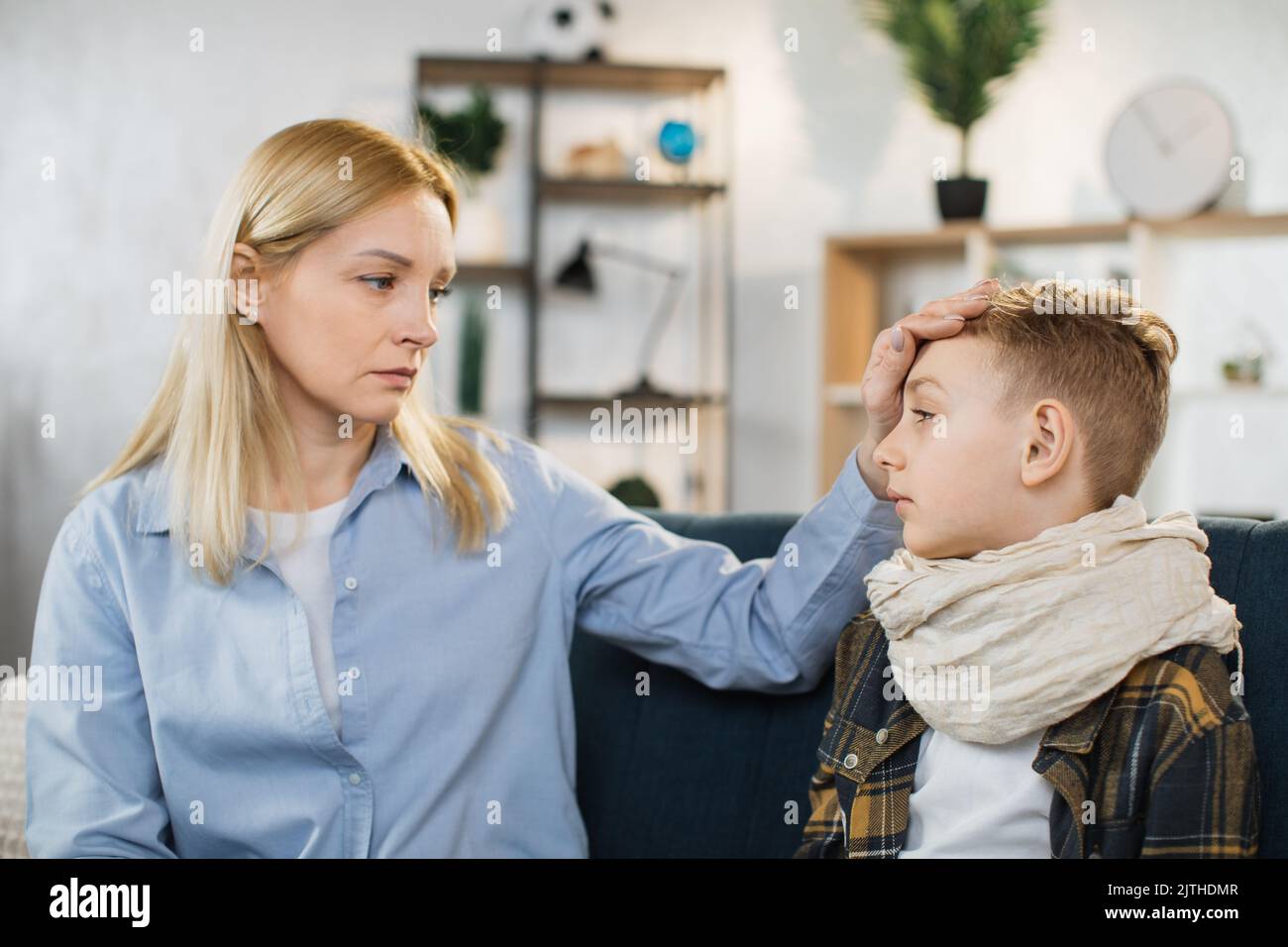 Stay at home. Mother taking care of her cute sick teen boy suffering ...