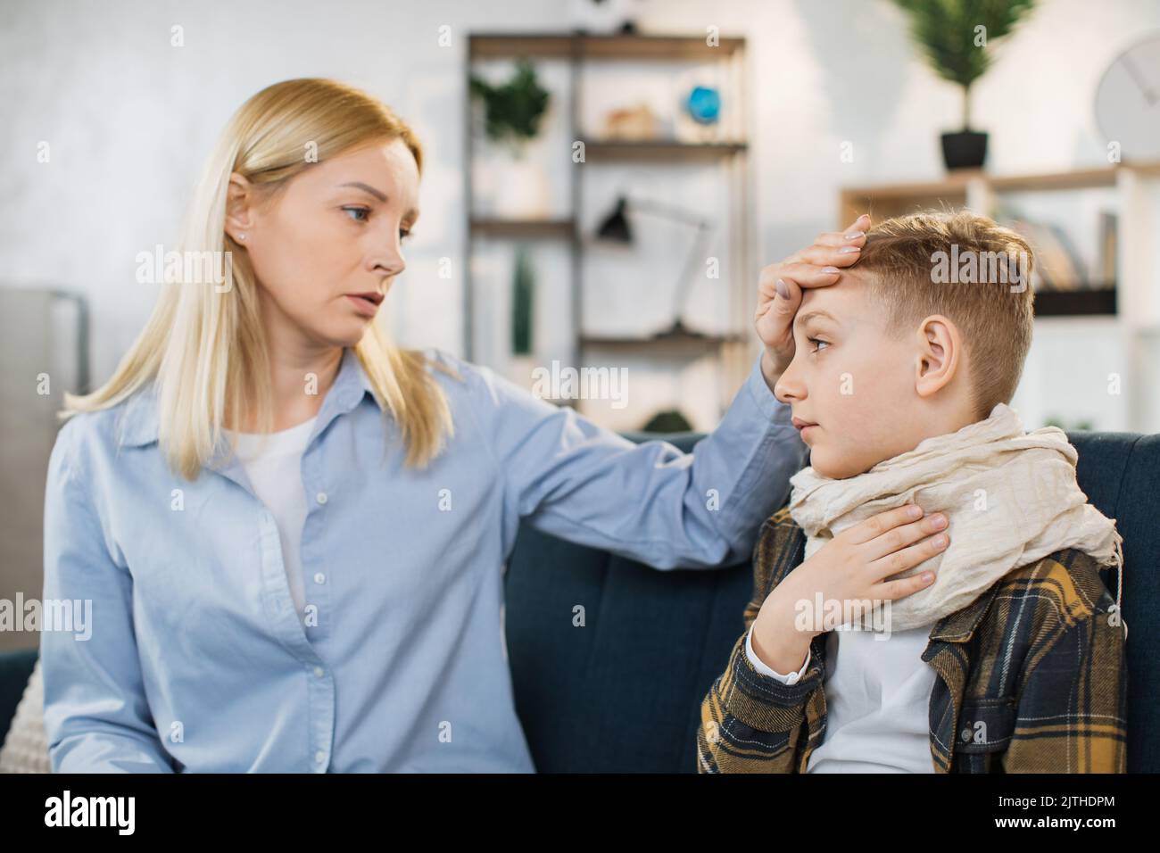 Stay at home. Mother taking care of her cute sick teen boy suffering ...