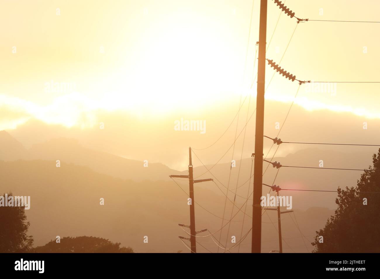 Silhouette of power lines during sunrise, rural California Stock Photo ...