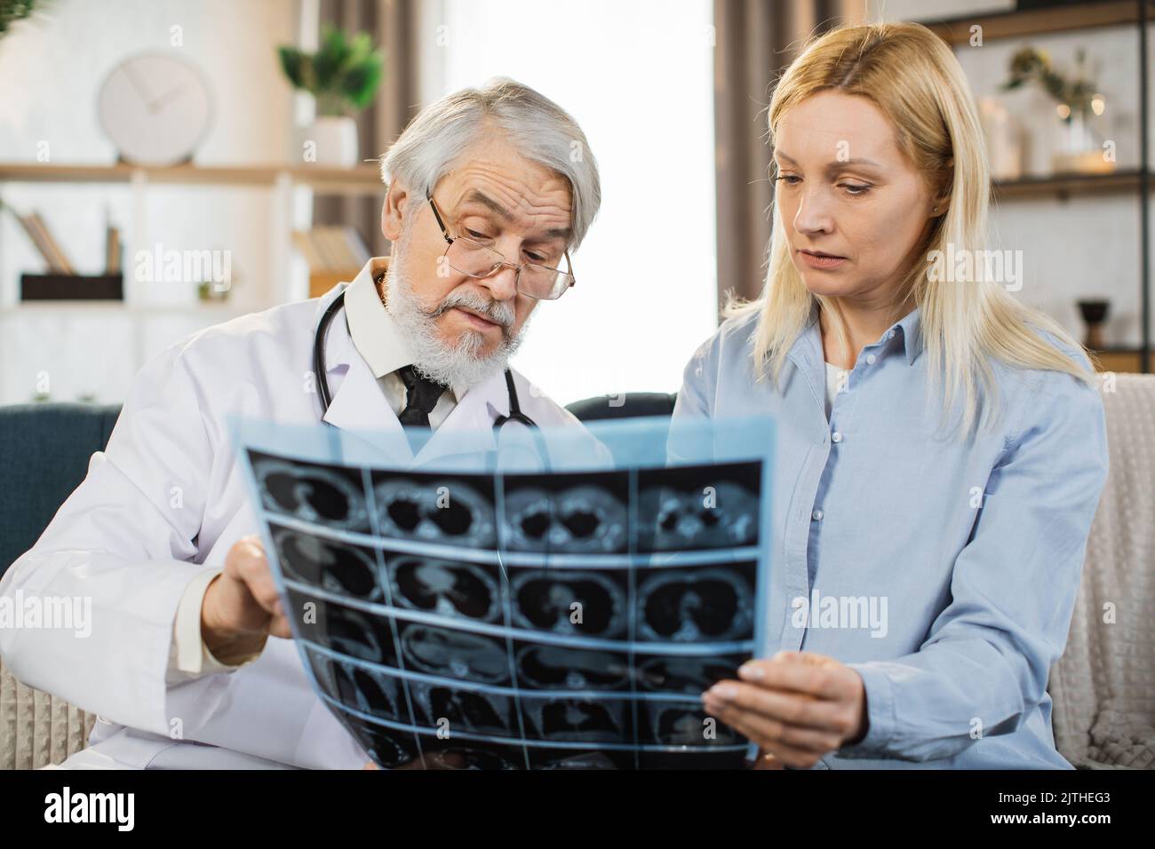 Senior bearded man confident doctor discussing the results of x-ray CT ...