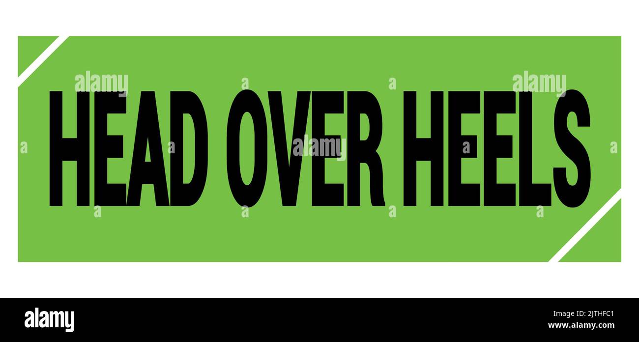 HEAD OVER HEELS text written on green-black grungy stamp sign Stock ...
