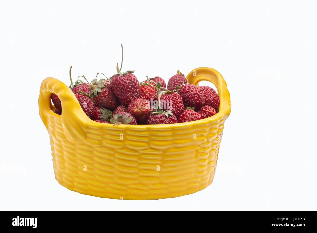 Strawberries in yellow deep dishe isolated on white background. natural ...
