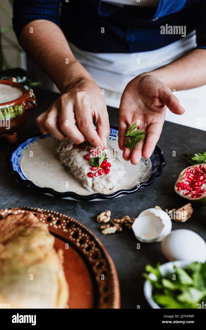 mexican woman cooking chiles en nogada recipe with Poblano chili and ...