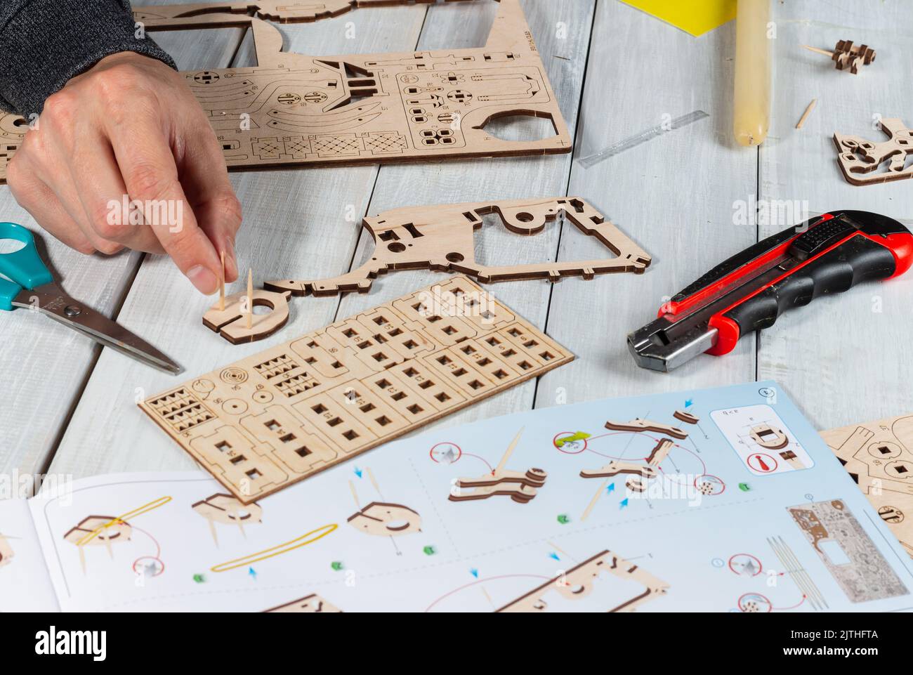 Concentrated dad making wooden toy as part of DIY homework. man's hand ...