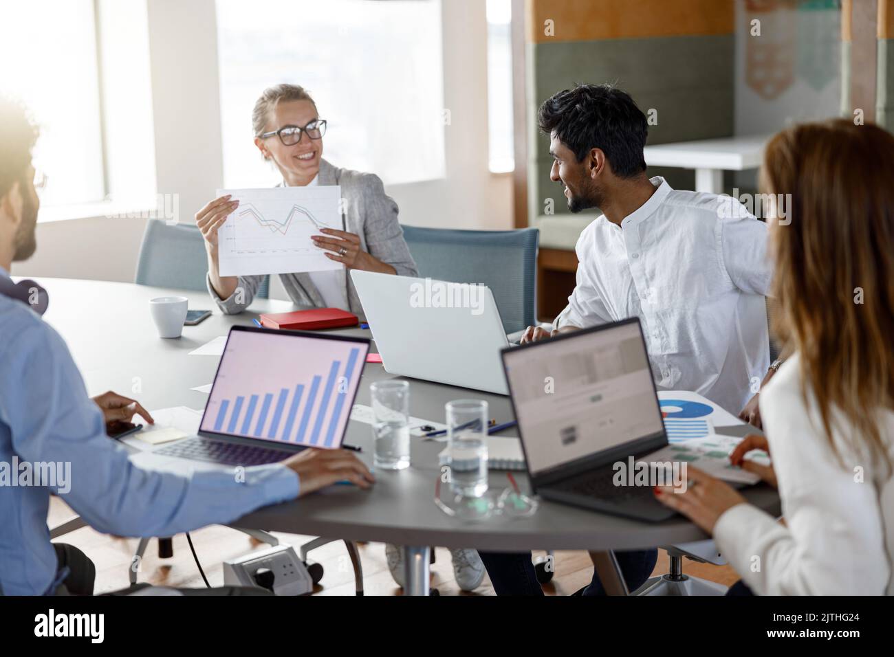 Busy coworkers cooperating and working together at office meeting ...