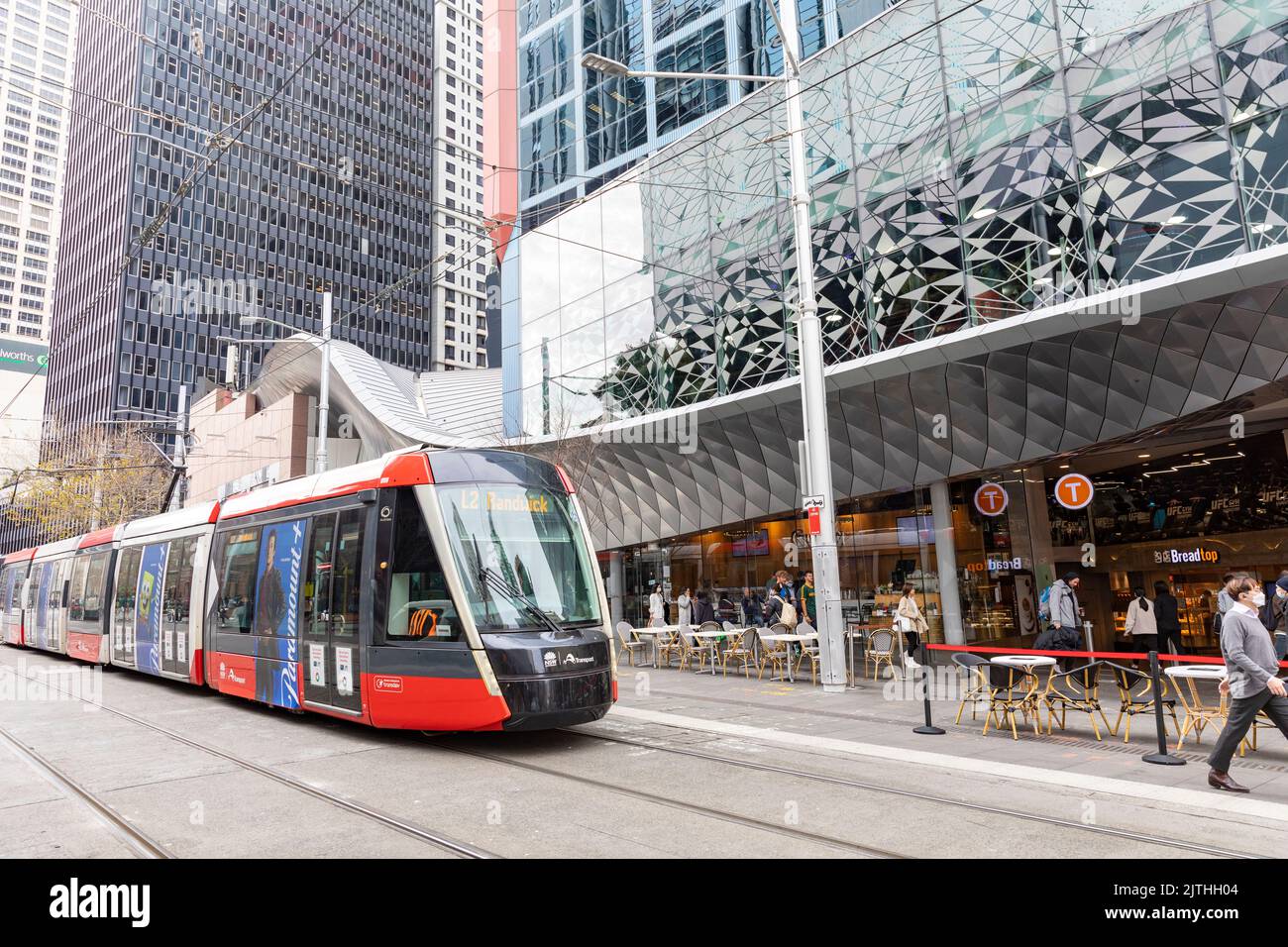 Sydney light rail train travelling along George street past office ...