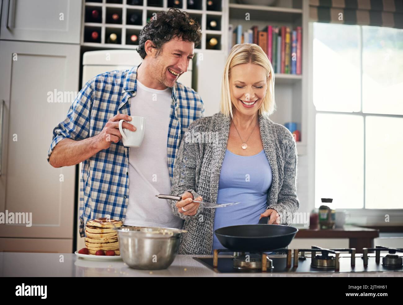 Whats cooking, good looking. a happy couple making breakfast together ...