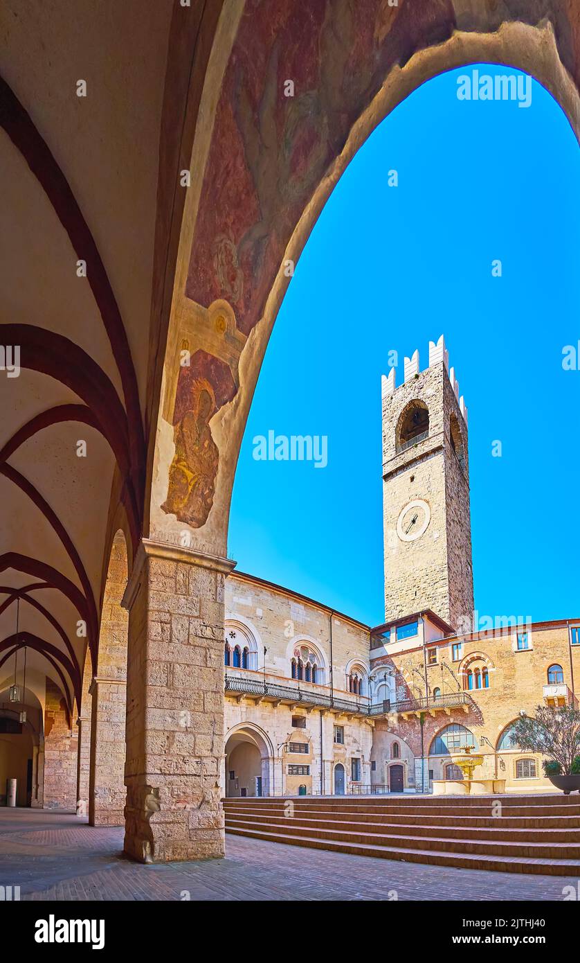 Arcade of Palazzo Broletto, observing the courtyard and Torre del Pegol ...