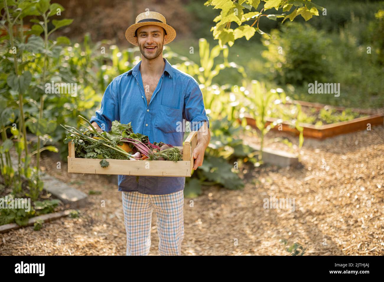 Farmer with freshly picked vegetables at garden Stock Photo - Alamy