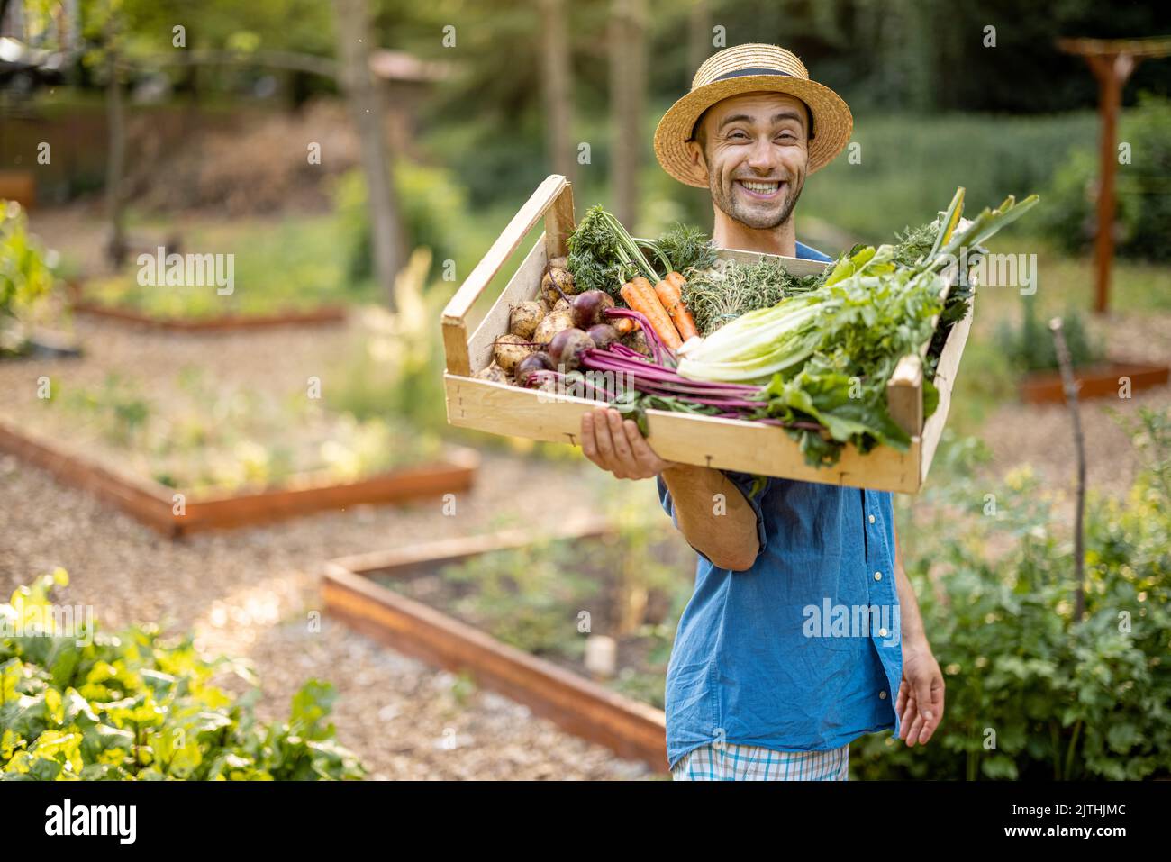 Farmer with freshly picked vegetables at farmland Stock Photo - Alamy