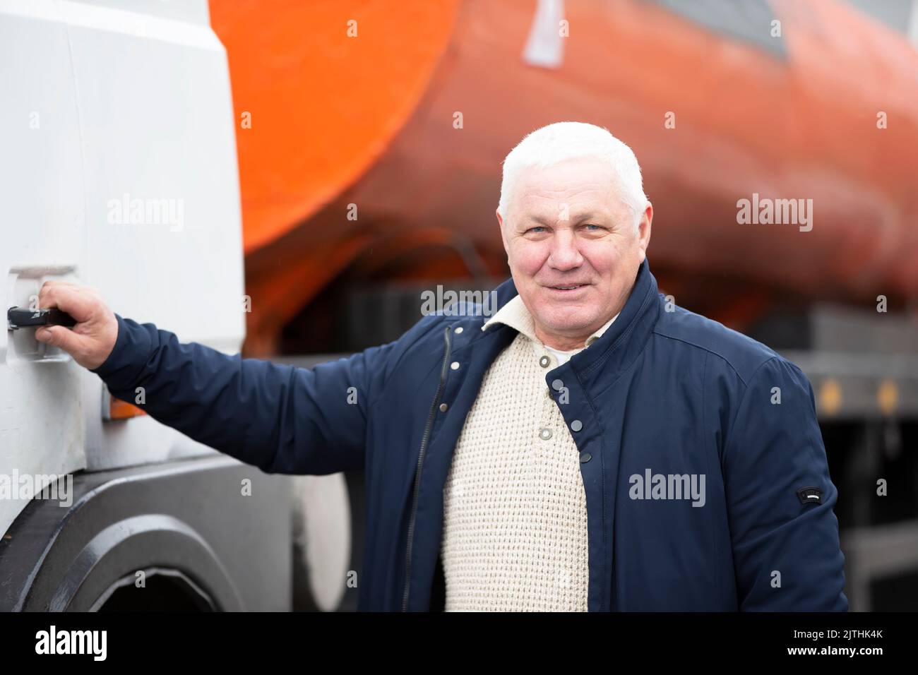 An elderly driver at the cab of a large truck Stock Photo - Alamy