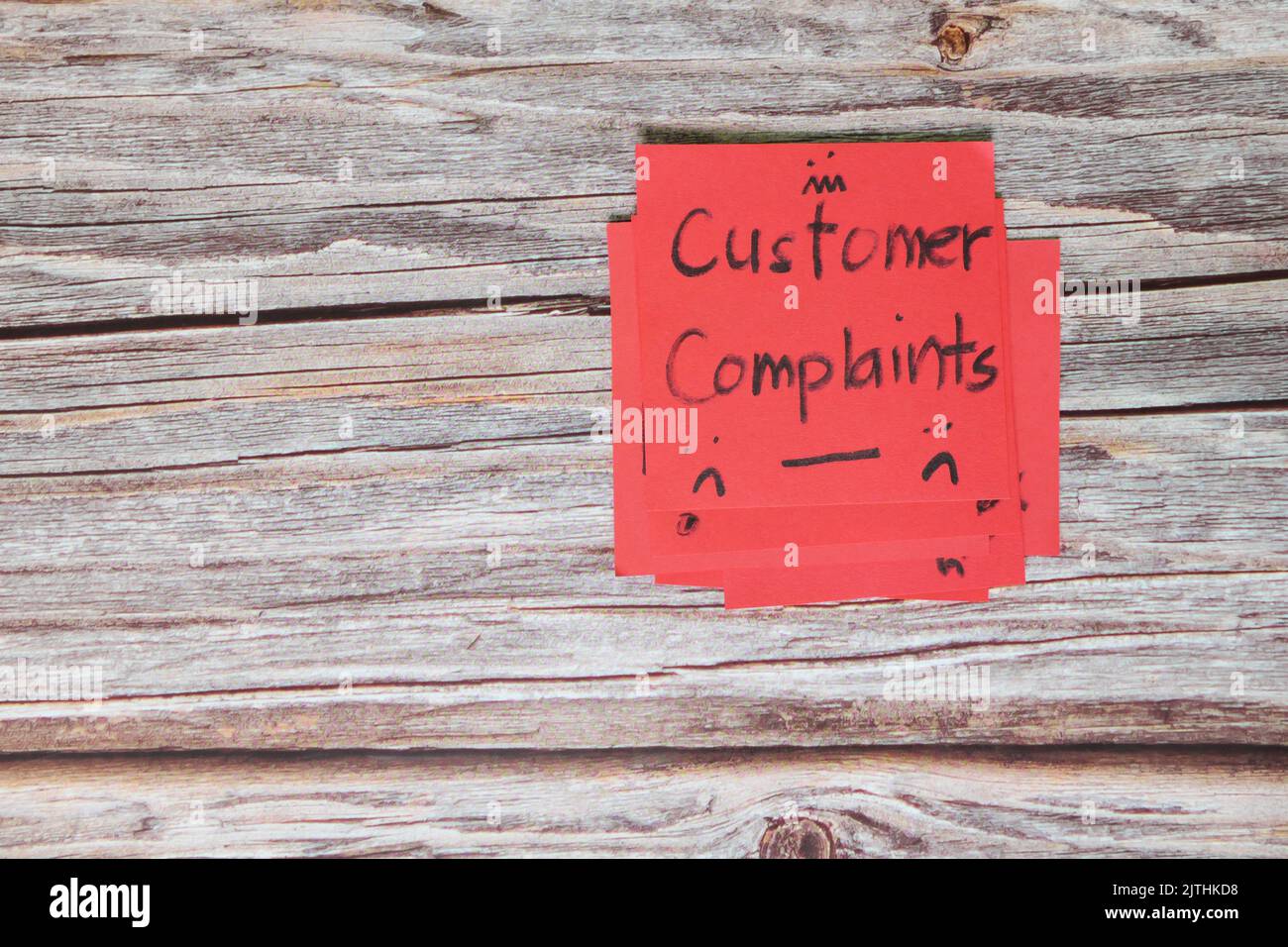 How to handle customer complaint concept. Hand holding red note with written word complaints ...