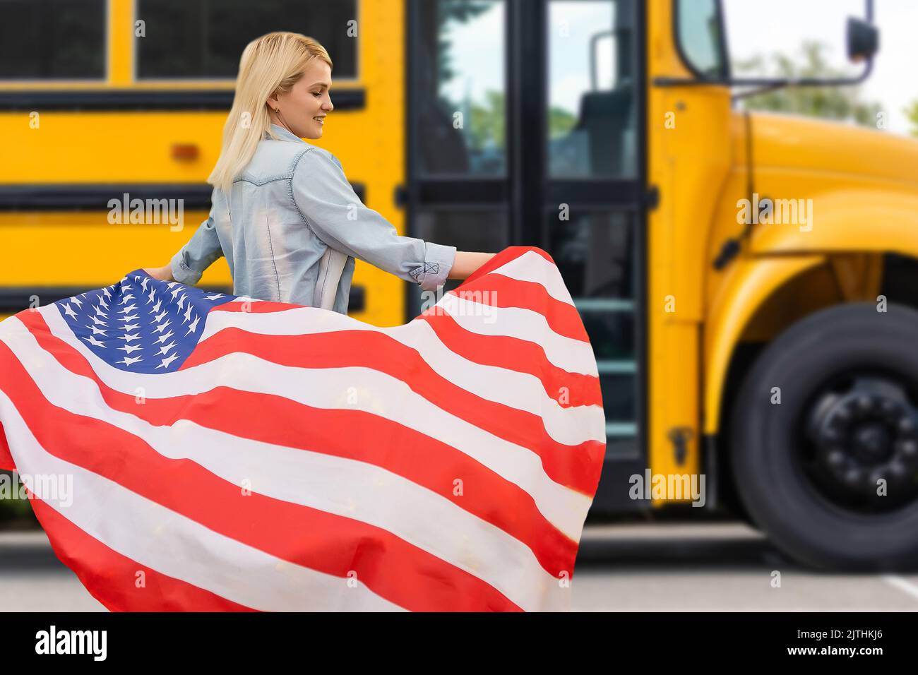 woman with national flags of USA near the school bus Stock Photo - Alamy