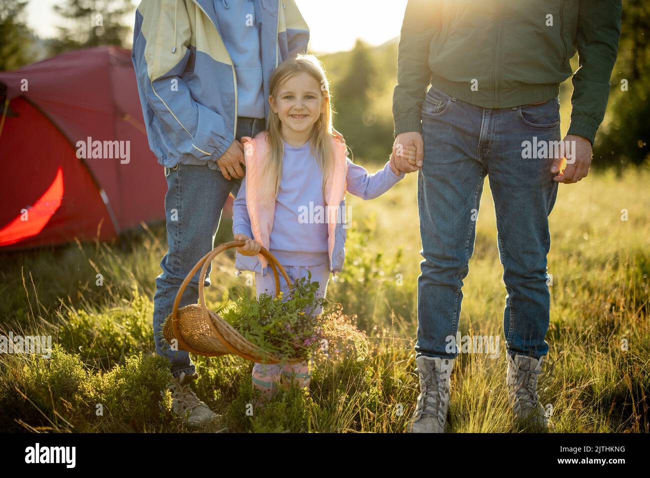 Portrait of little girl with wildflowers and parents on nature Stock ...