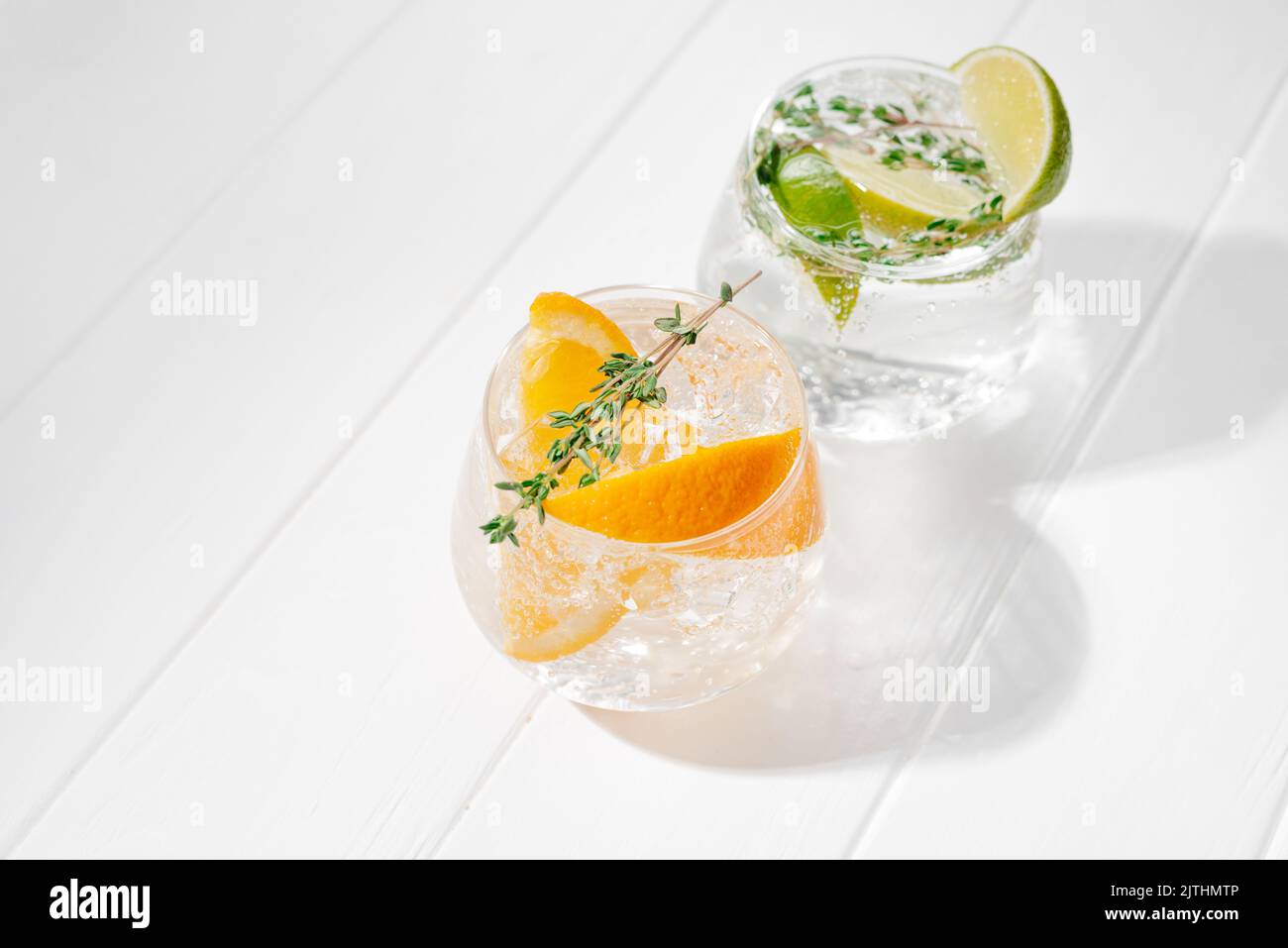 Set of different citrus lemonades with orange and lime on a light ...