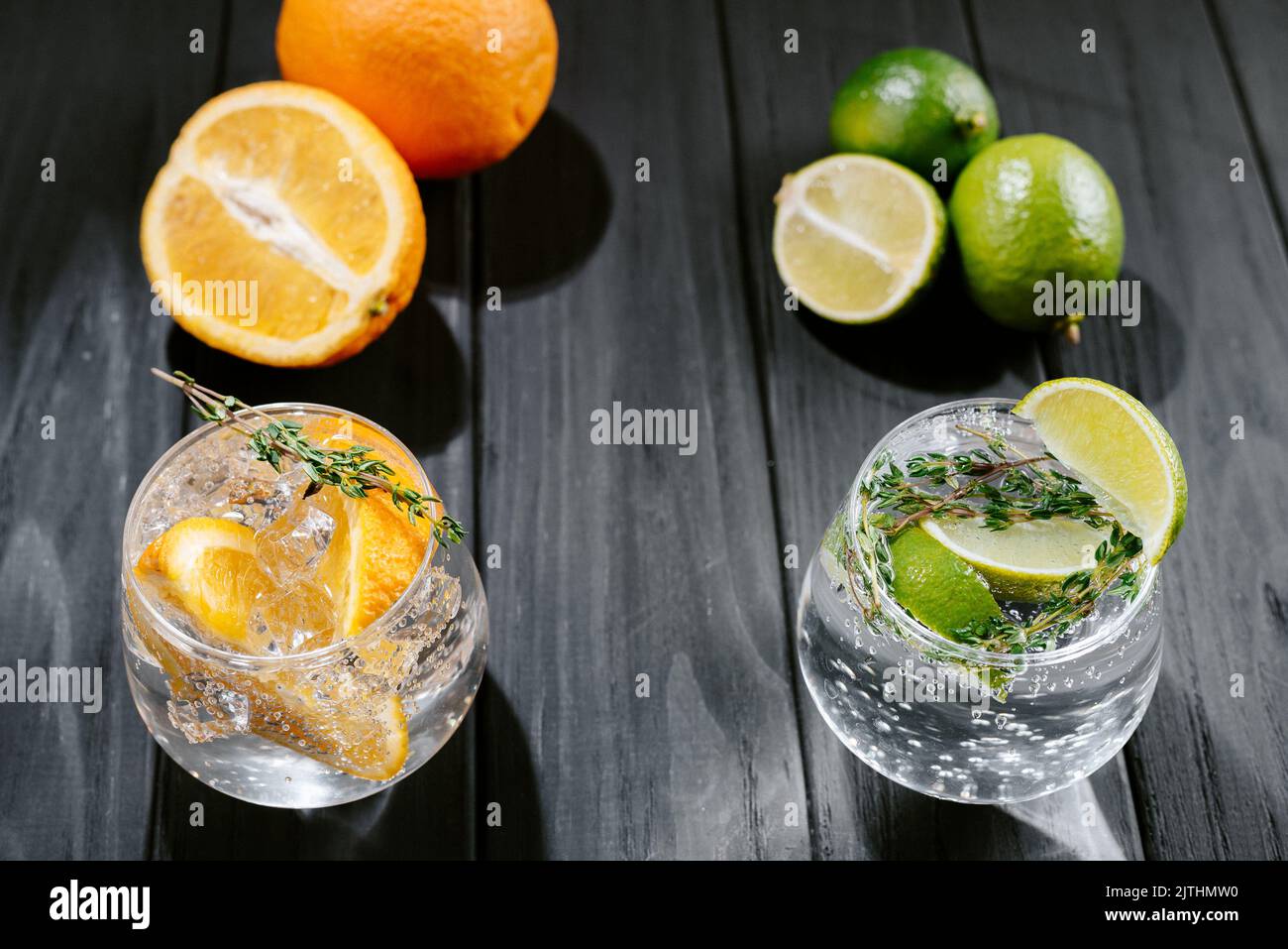 Lime lemonade with thyme, ginger and ice and orange. wooden dark ...