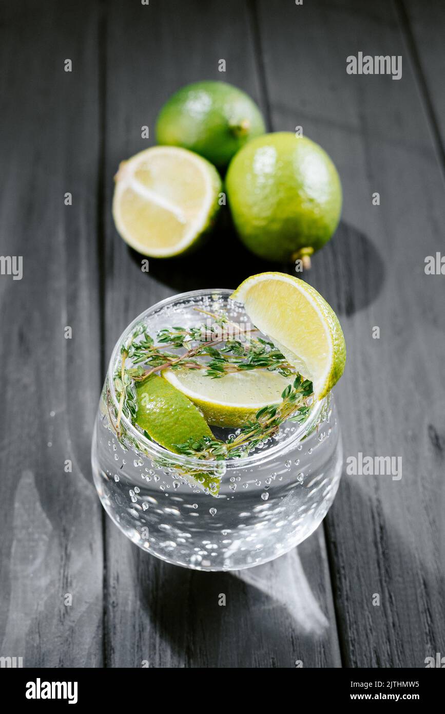 Lime lemonade with thyme, ginger and ice. wooden dark background ...
