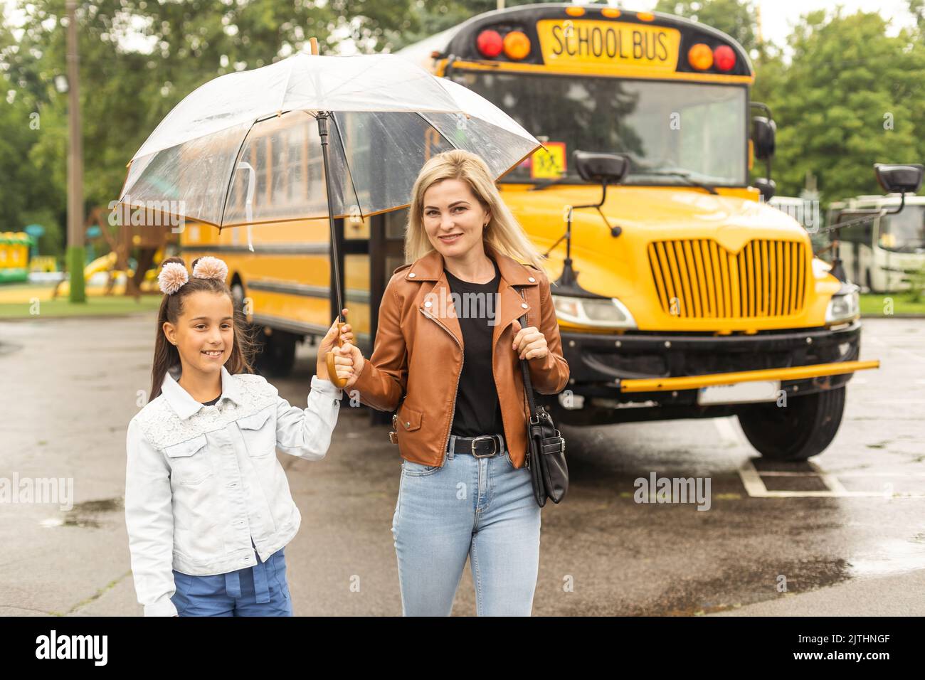 Back to school. Pupils of primary school near school bus. Happy ...