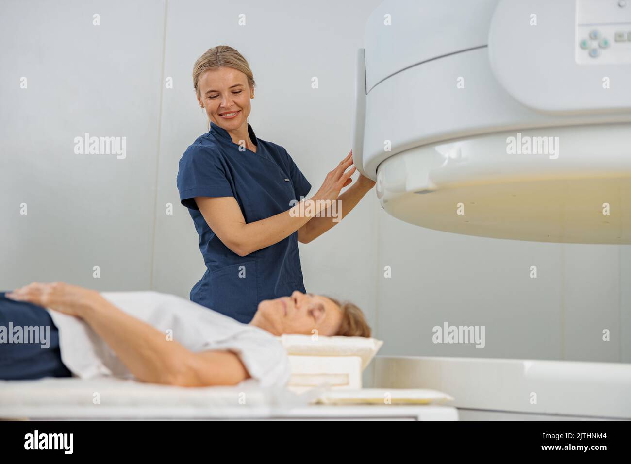 Radiologist controls MRI or CT or PET Scan with female patient ...