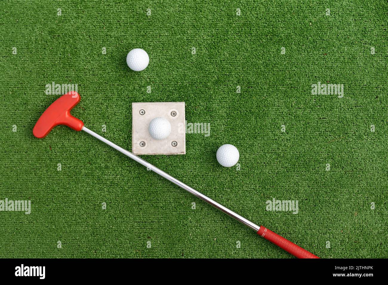 A golf club and a ball during a mini golf game Stock Photo - Alamy