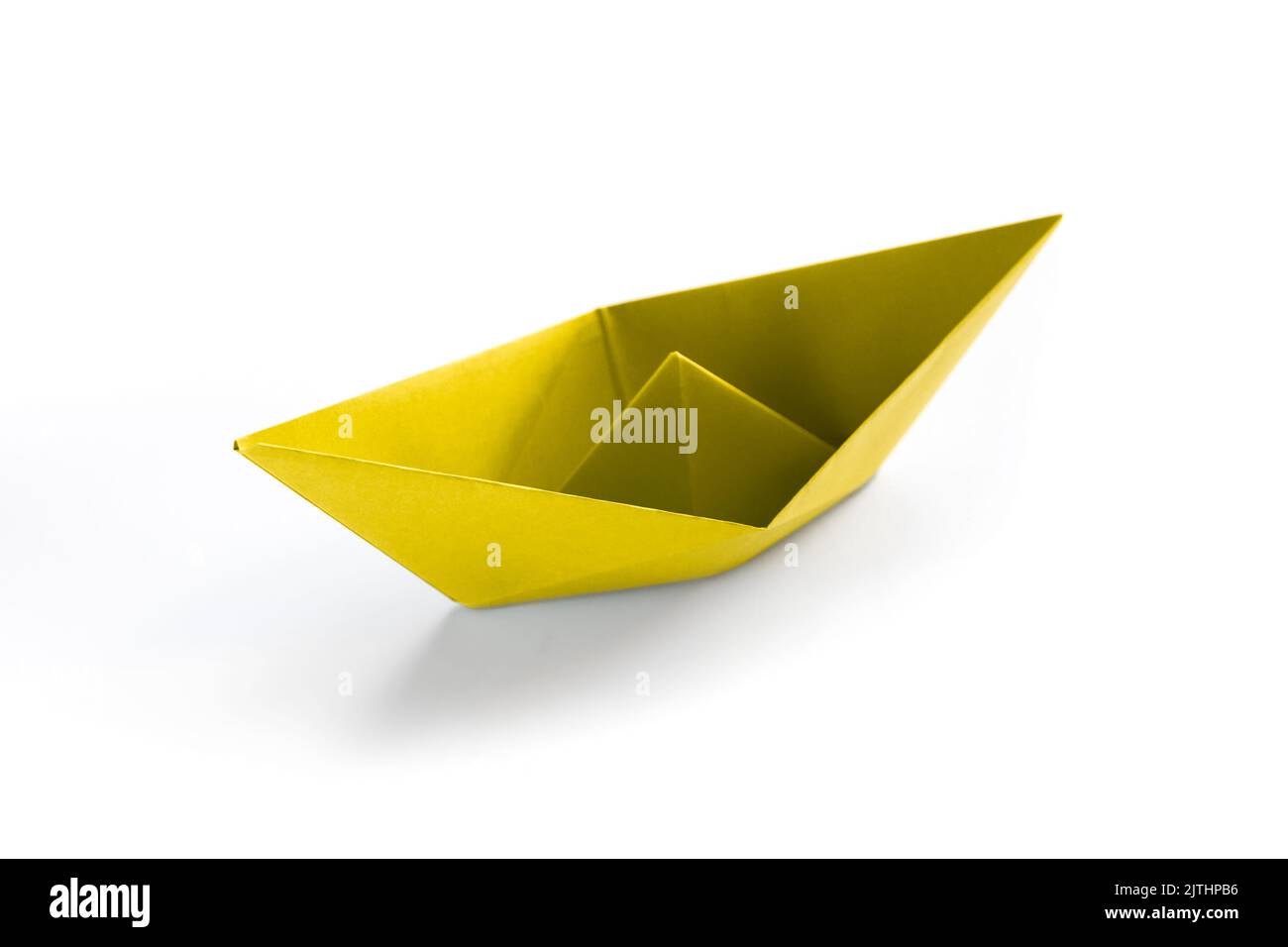 Yellow paper boat origami isolated on a blank white background Stock ...