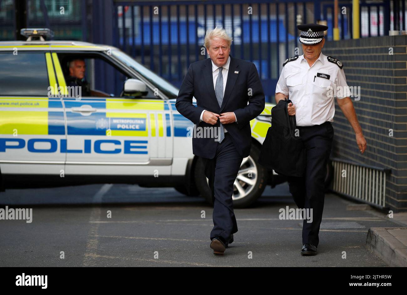 Prime Minister Boris Johnson walks with Stephen House, acting ...