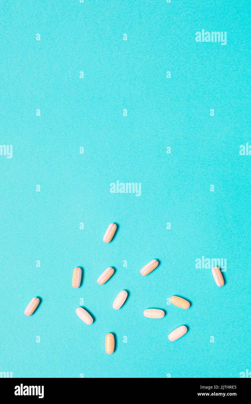 Tablets drugs therapy antibiotic on pastel blue background from above ...