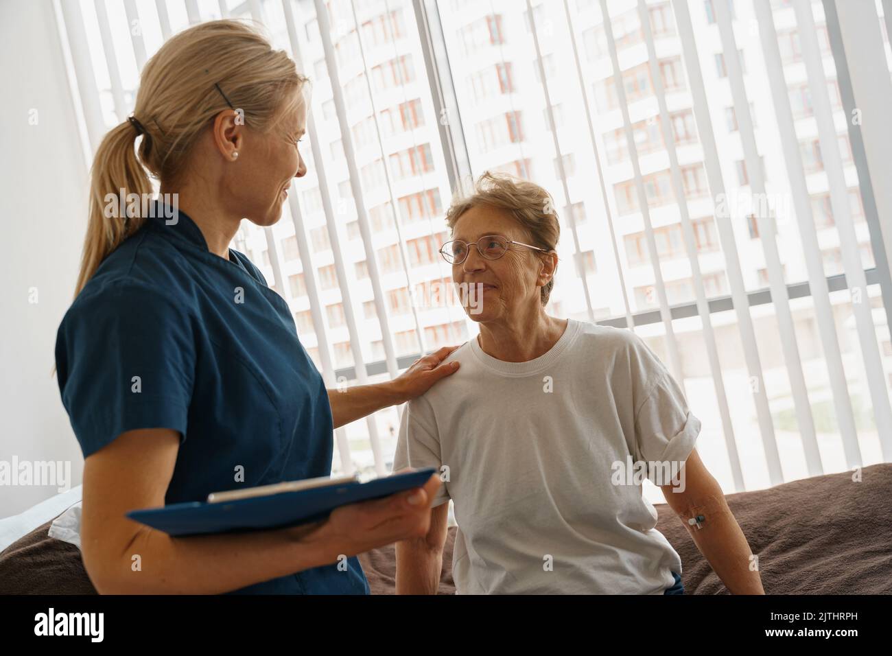 Doctor supporting a sick patient before medical procedures in a ...