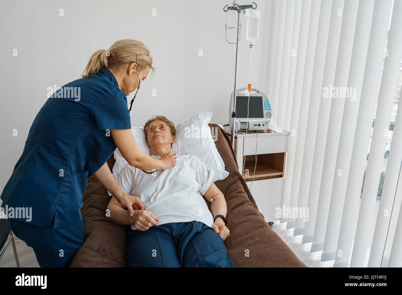 Female doctor therapist listening to old woman's patient breathing ...