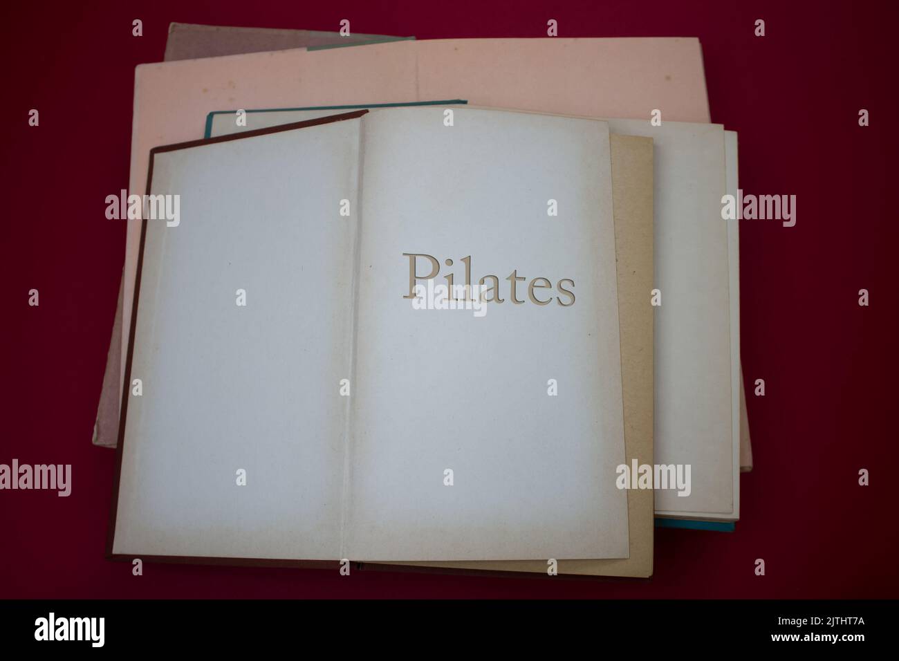 Pilates word in opened book with vintage, natural patterns old antique ...