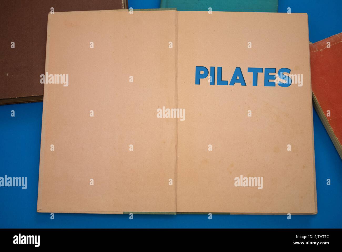 Pilates word in opened book with vintage, natural patterns old antique ...