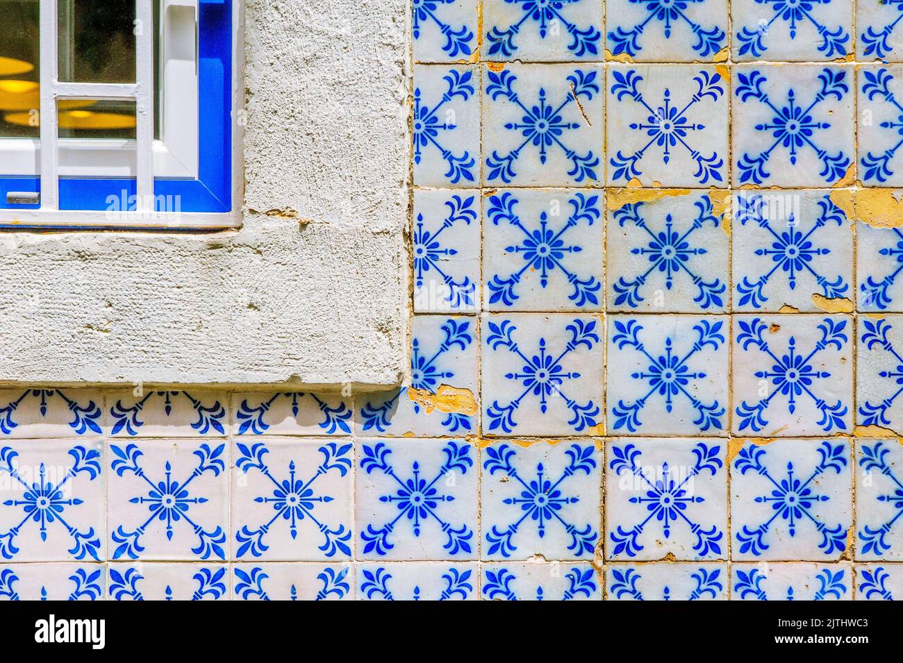 A Spanish window with blue and white tiles on the wall Stock Photo - Alamy