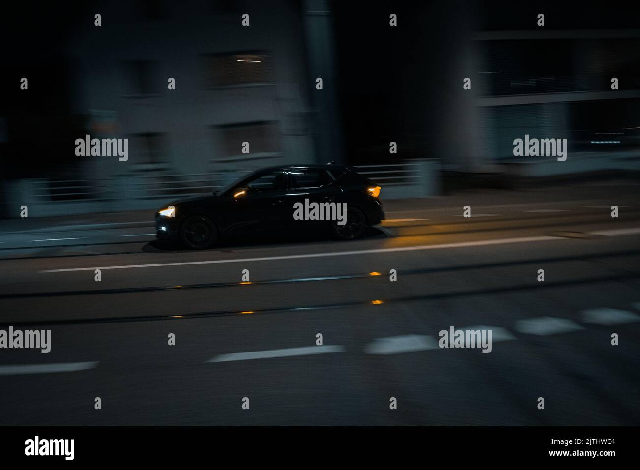 Black car driving at night hi-res stock photography and images - Alamy