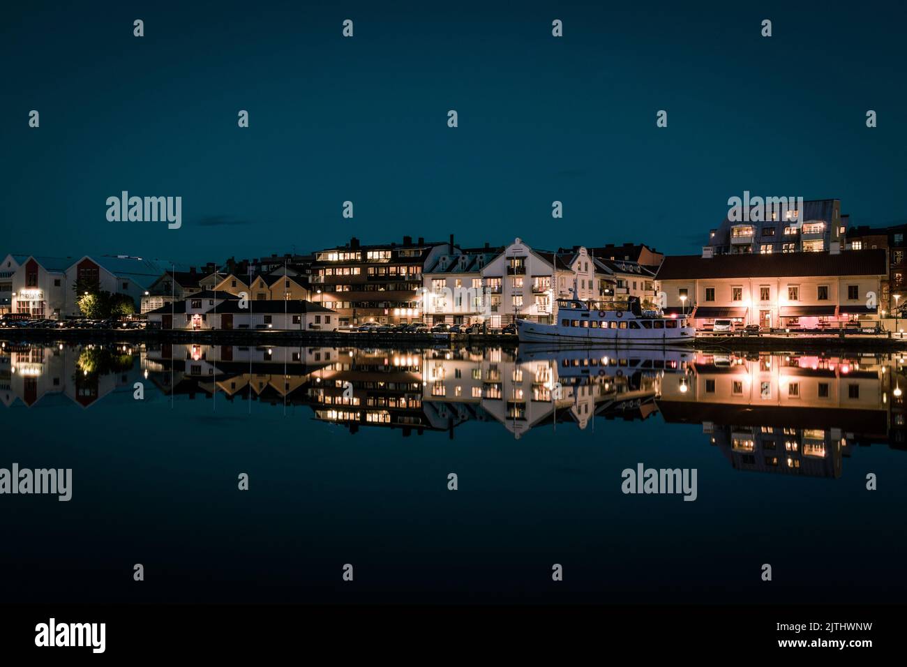 A building with bright lights and its reflection to the water Stock ...