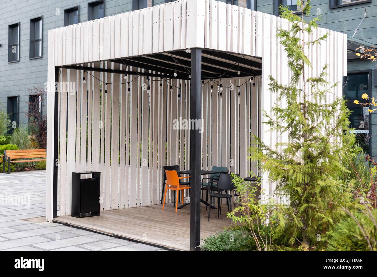 Beautiful wooden carved open alcove, arbor in city park in spring ...