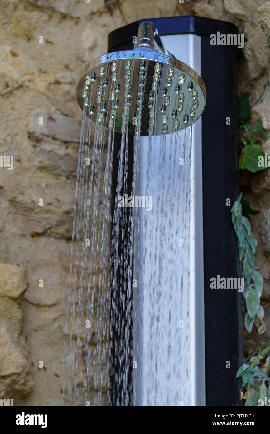 outdoor shower running water over a stone wall Stock Photo - Alamy
