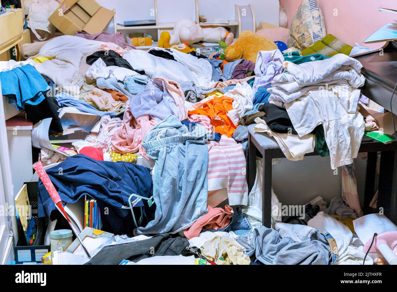 A room cluttered with piles of clothes Stock Photo - Alamy