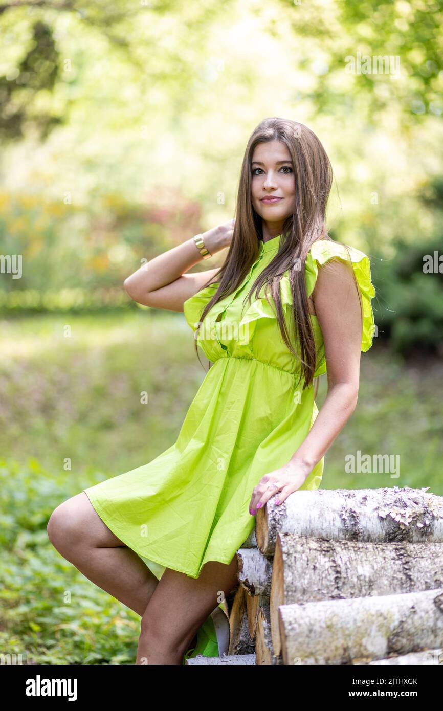 The Vertical View Of A Caucasian Female Model Wearing A Green Dress