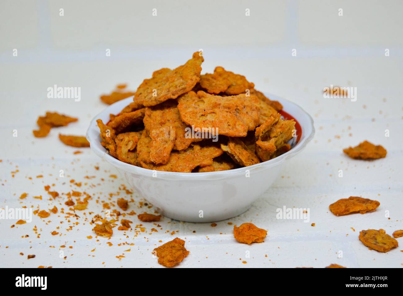 Tasty and delicious tempeh chips in a bowl with a white background ...
