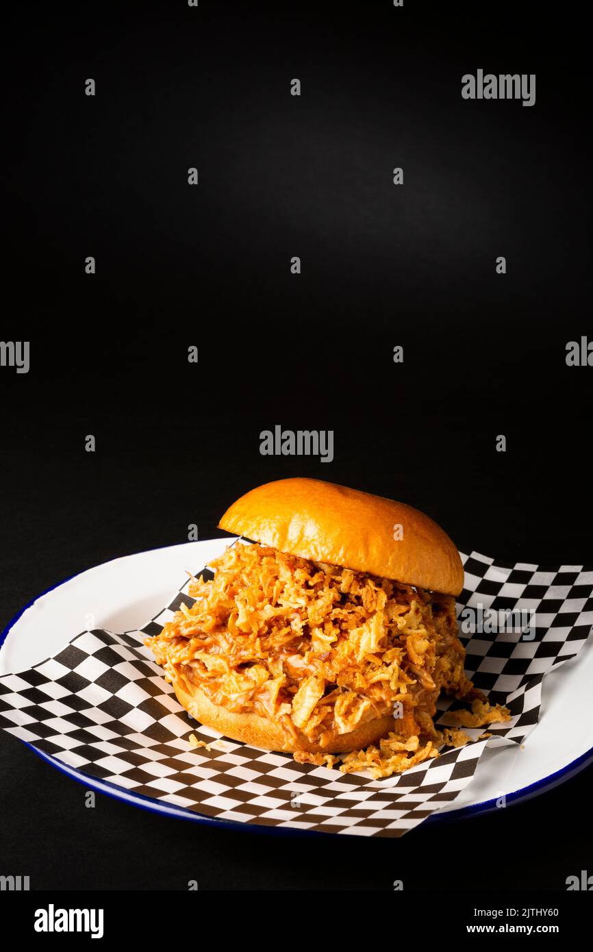 Pulled chicken burger over a black background Stock Photo - Alamy