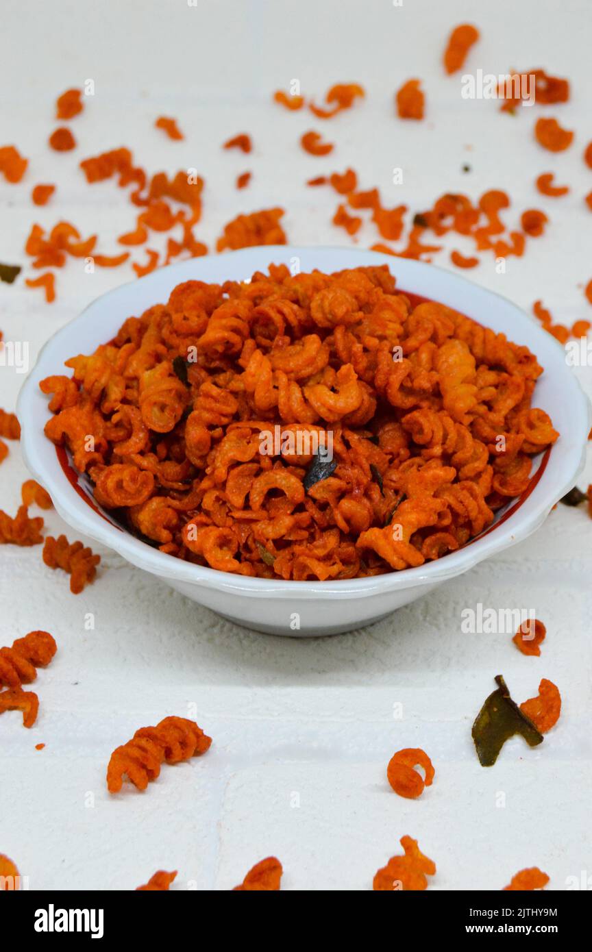 Savory and crunchy spicy macaroni in a bowl on a white background ...