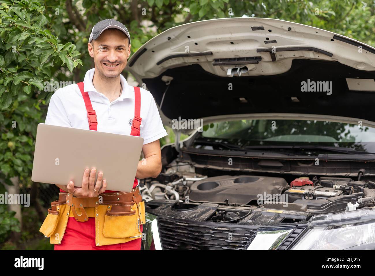 Mechanic man close up using laptop computer examining tuning fixing ...