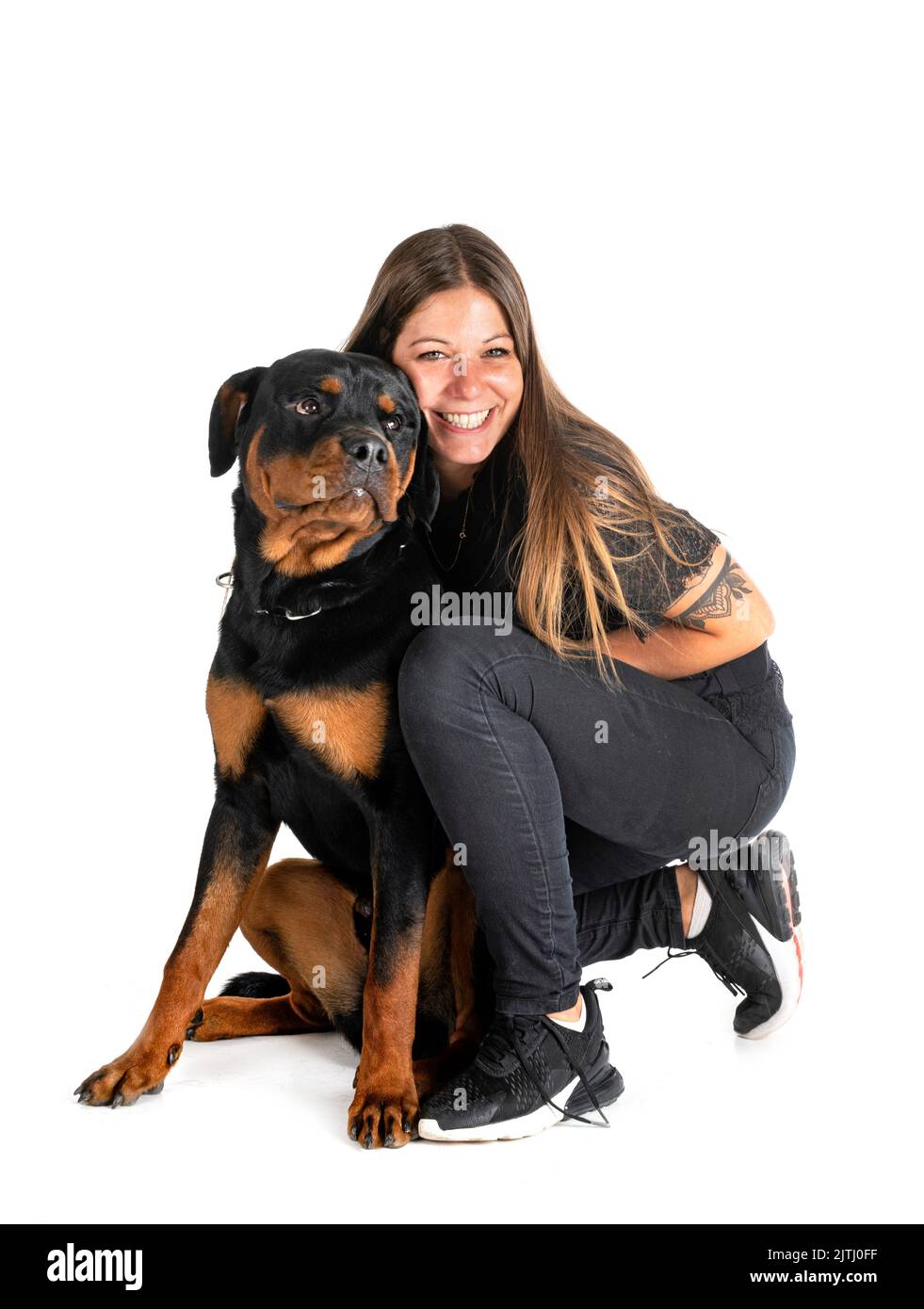 puppy rottweiler and woman in front of white background Stock Photo - Alamy